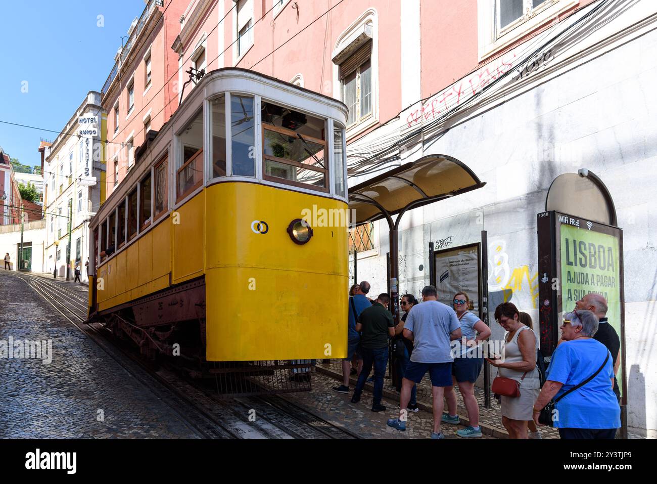 People standing in line for the Gloria Funicular at the bottom stop in ...