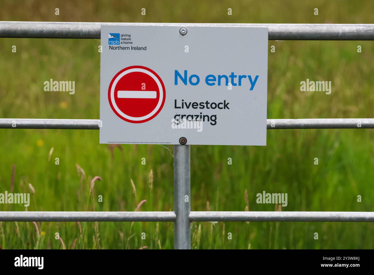 warning sign on metal farm gate no entry livestock grazing warning RSPB ...