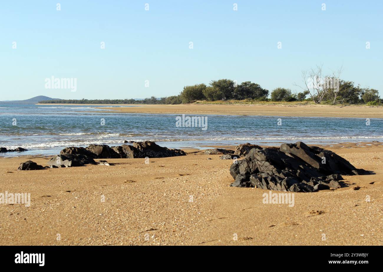 Sand, rocks and the ocean at Tannum Sands beach in Queensland ...