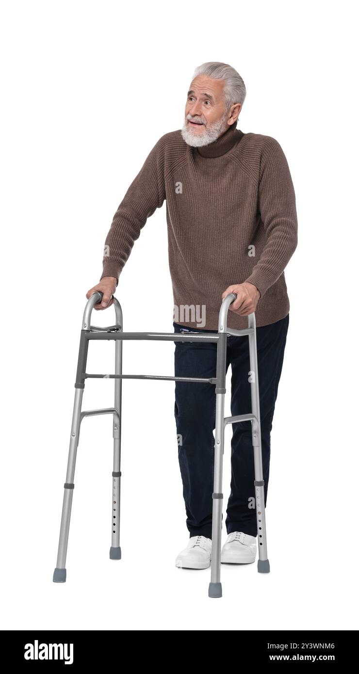 Senior man using walking frame on white background Stock Photo - Alamy