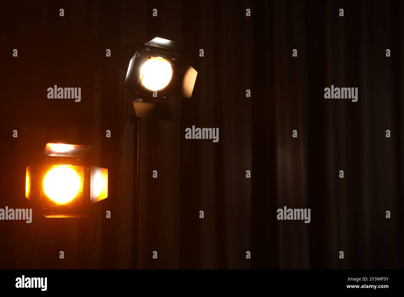 Professional spotlights against curtain. Space for text Stock Photo - Alamy