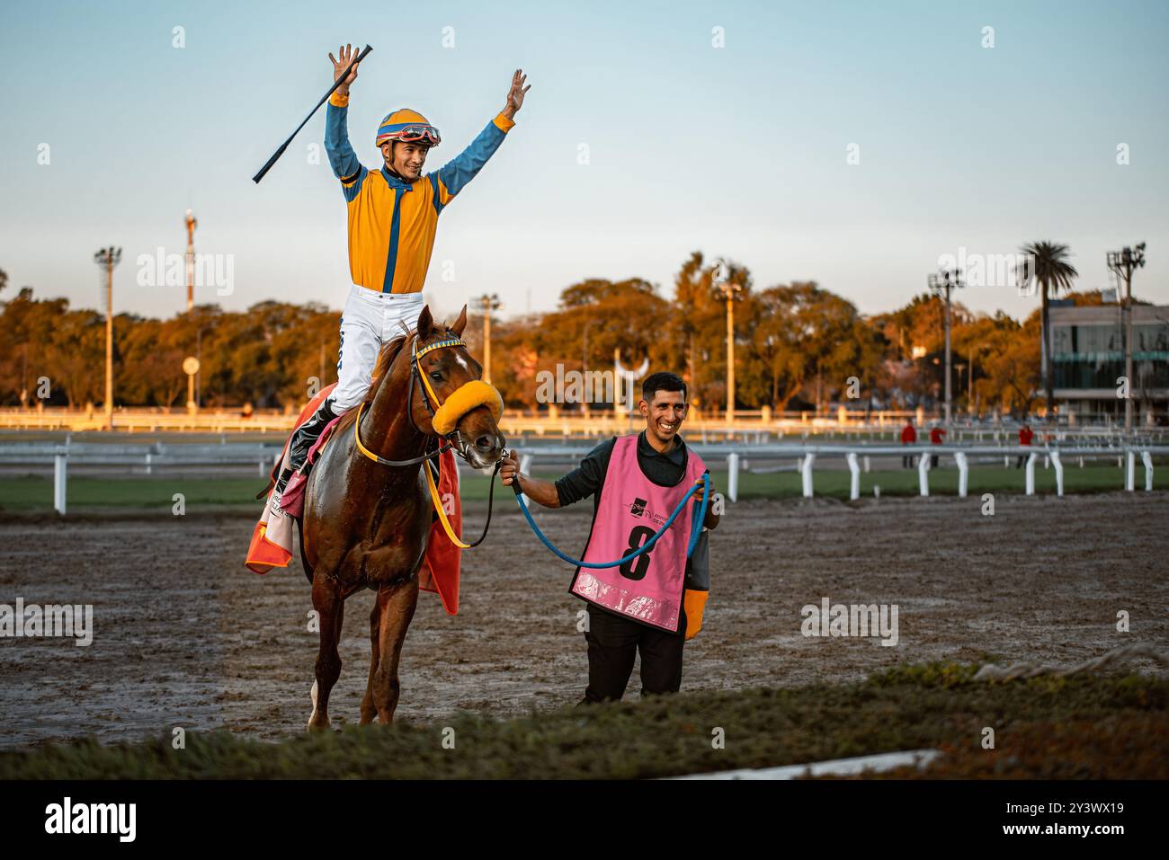 The winning jockey celebrates with the crowd and his team Stock Photo ...