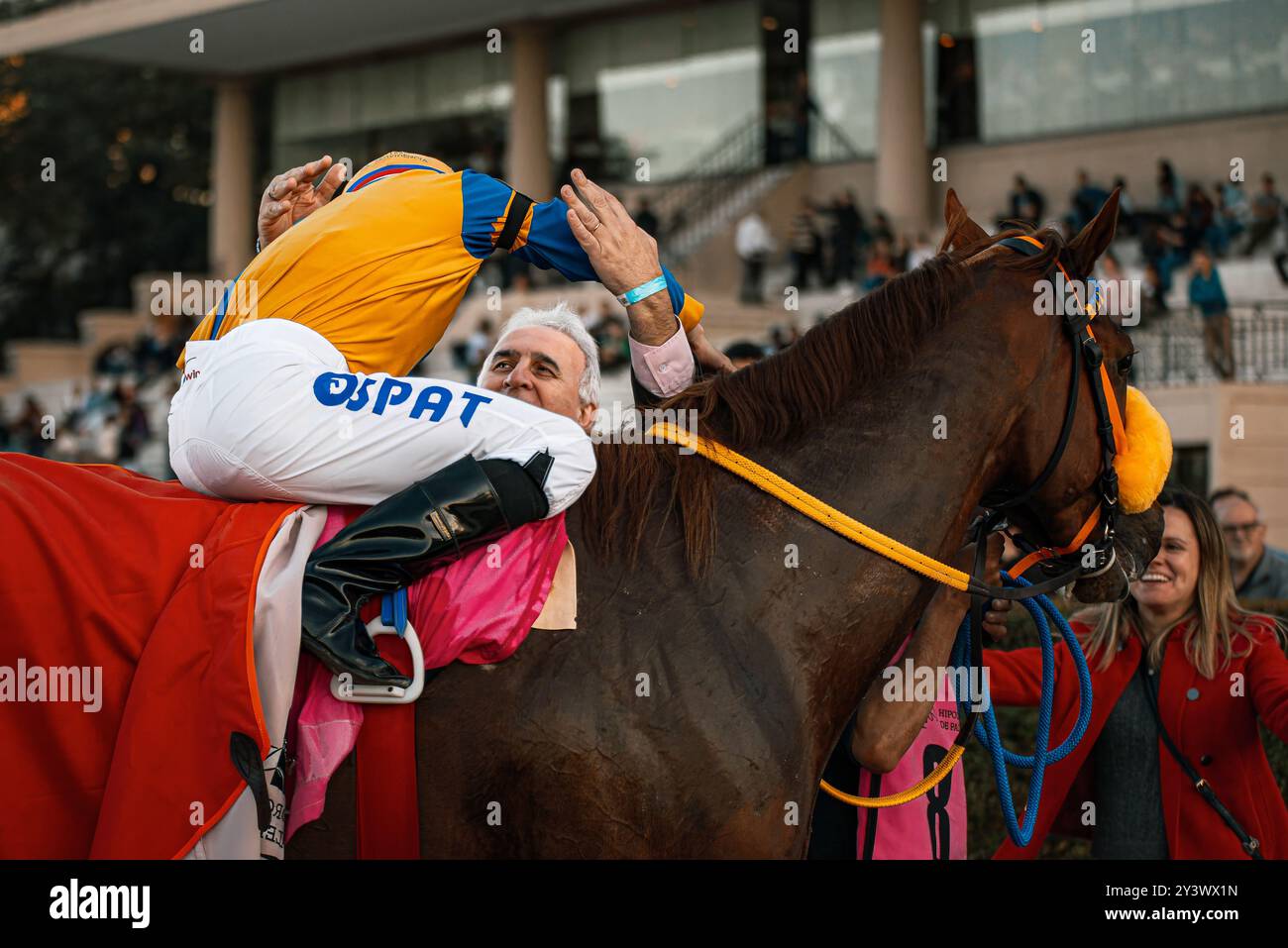 The winning jockey celebrates with the crowd and his team Stock Photo ...