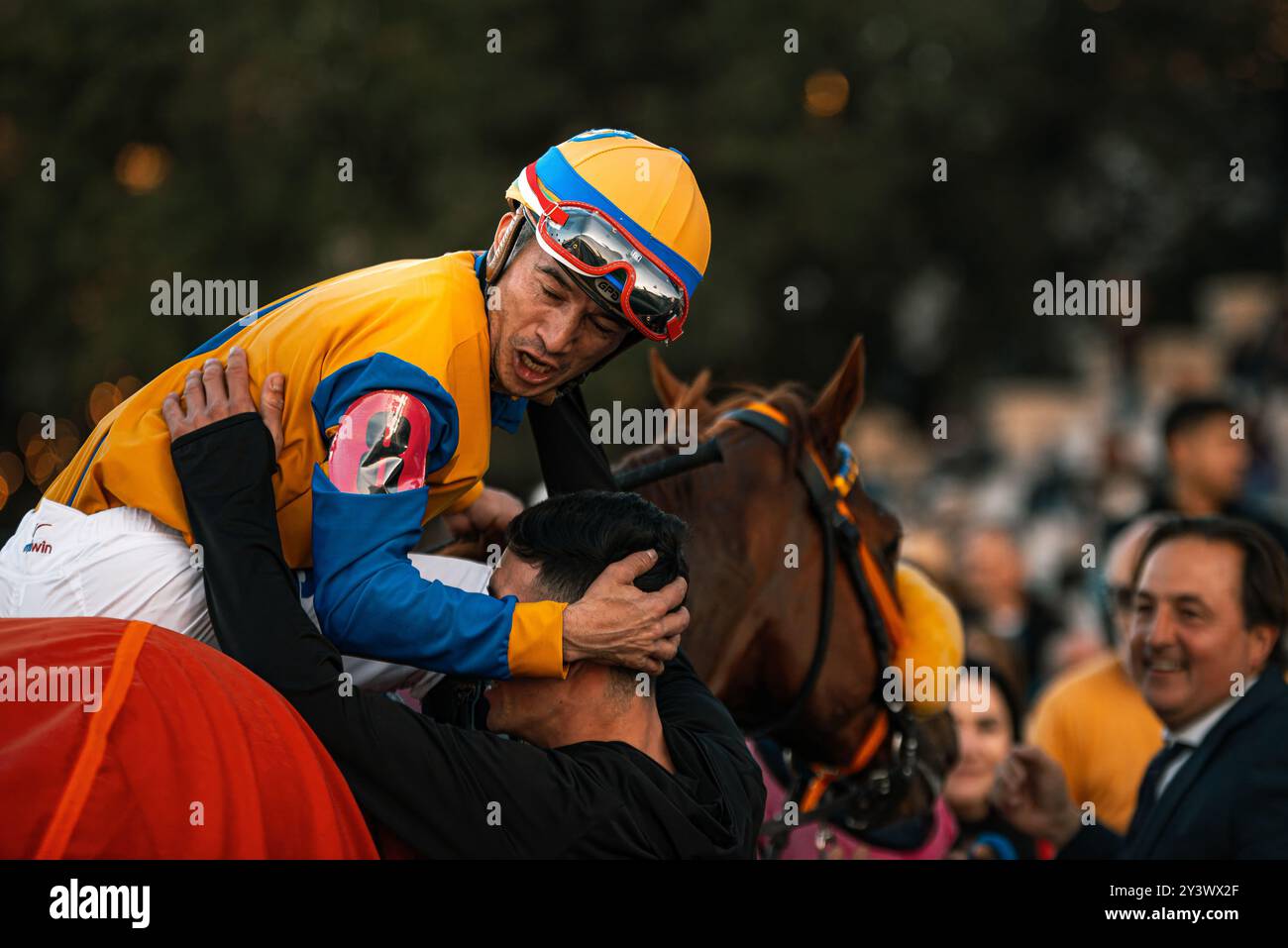 The winning jockey celebrates with the crowd and his team Stock Photo ...