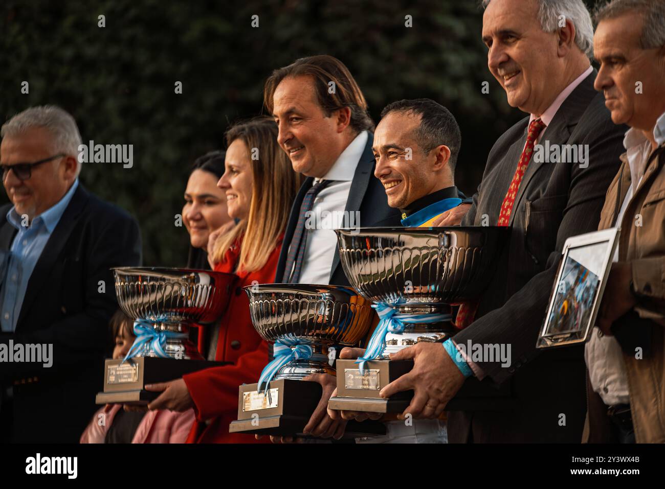 The winning jockey celebrates with the crowd and his team Stock Photo ...