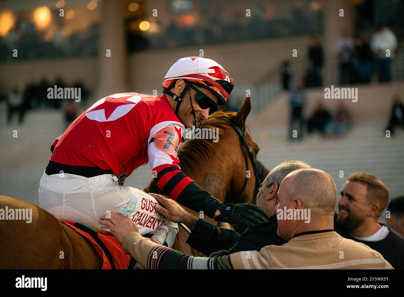The winning jockey celebrates with the crowd and his team Stock Photo ...