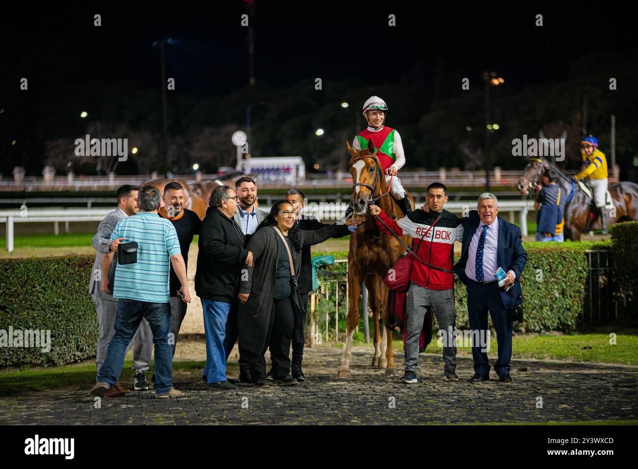 The winning jockey celebrates with the crowd and his team Stock Photo ...