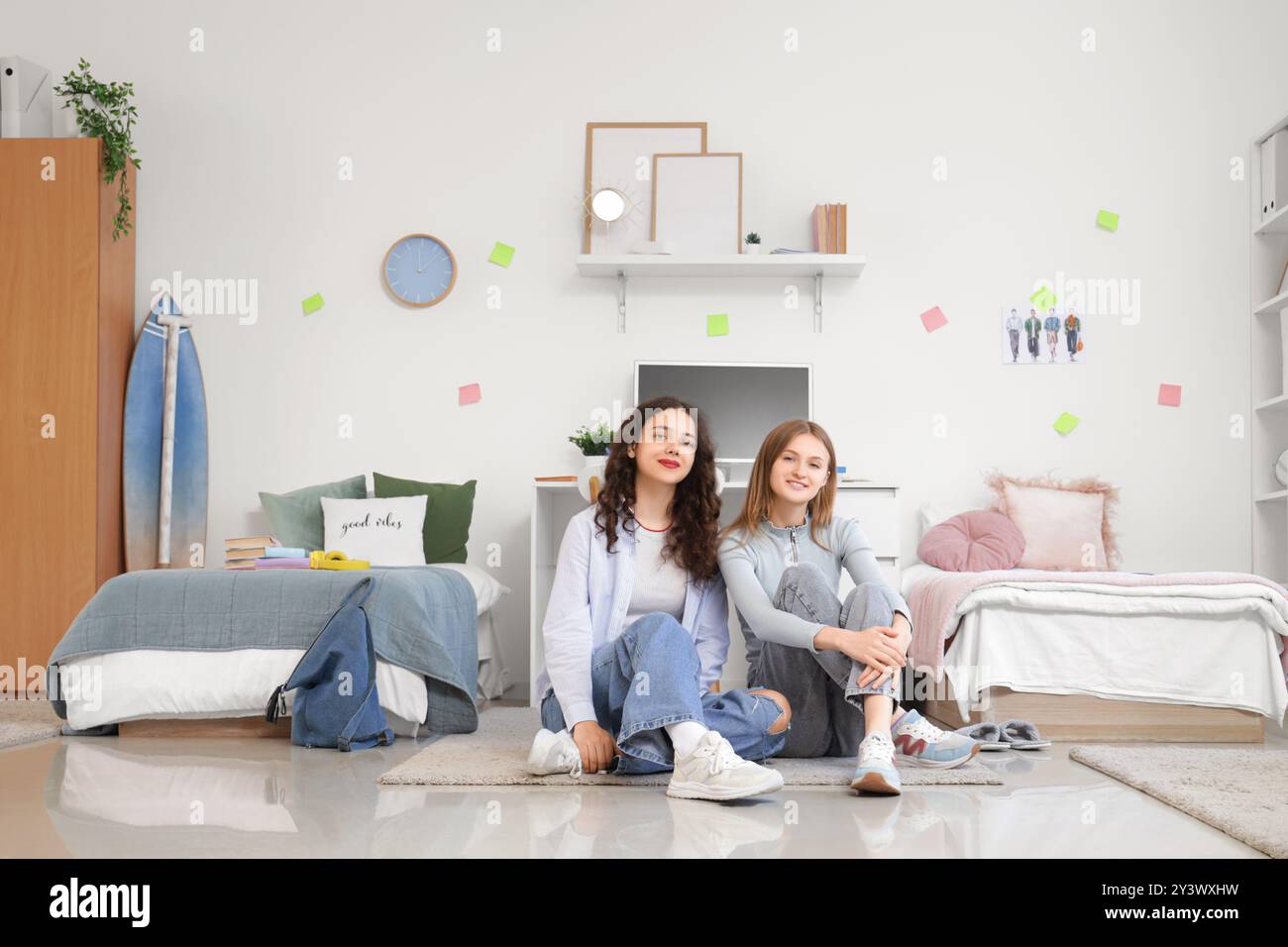 Female students sitting on floor in dorm room Stock Photo - Alamy