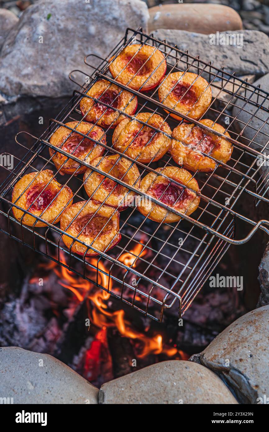 grilled peaches cooking over an open flame caramelized texture, vibrant ...
