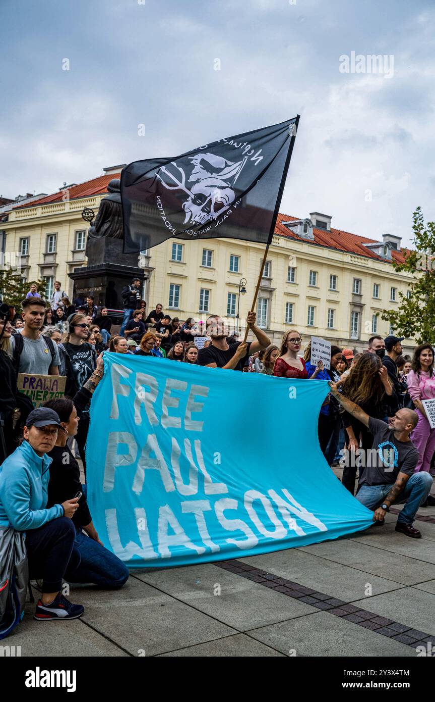 Protestors pose with a flag and banner calling for the release of ...