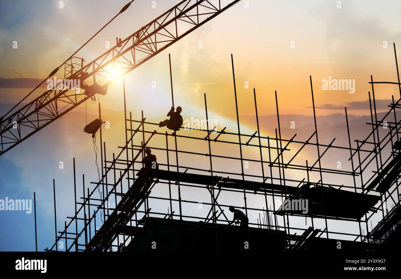 Group of construction workers working on scaffolding Stock Photo - Alamy
