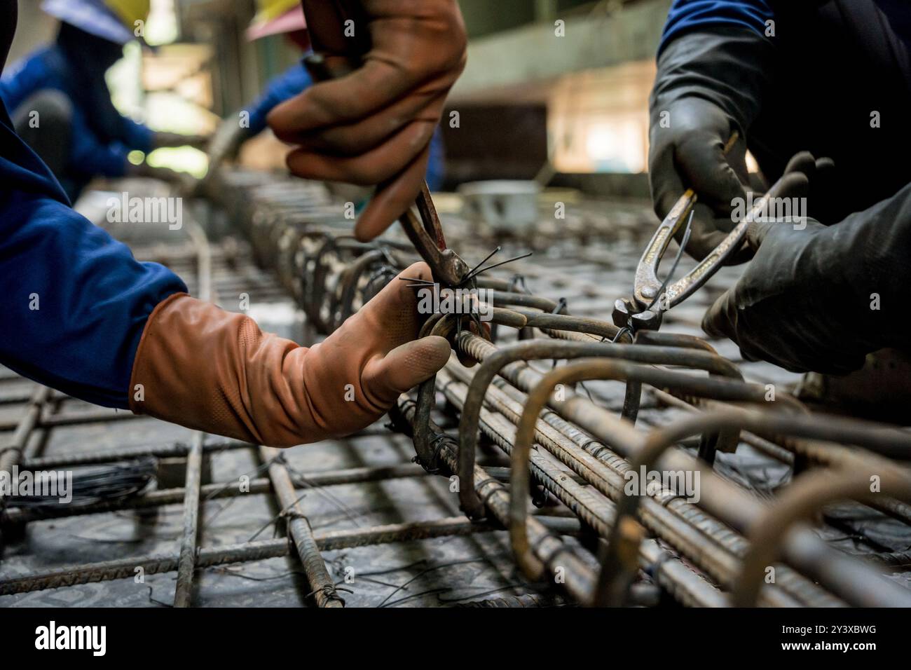A group of builders is busy constructing a metal structure Stock Photo ...