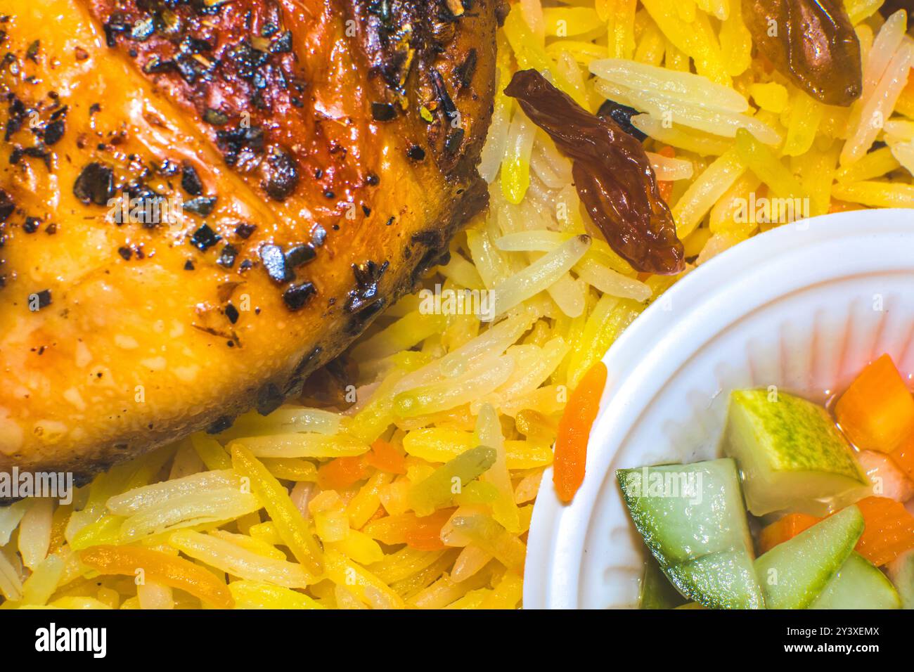Macro photo of rice served with roast chicken, raisins and vegetables ...