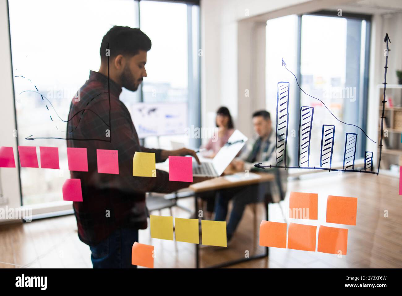 Business meeting with charts and post-it notes brainstorming Stock ...