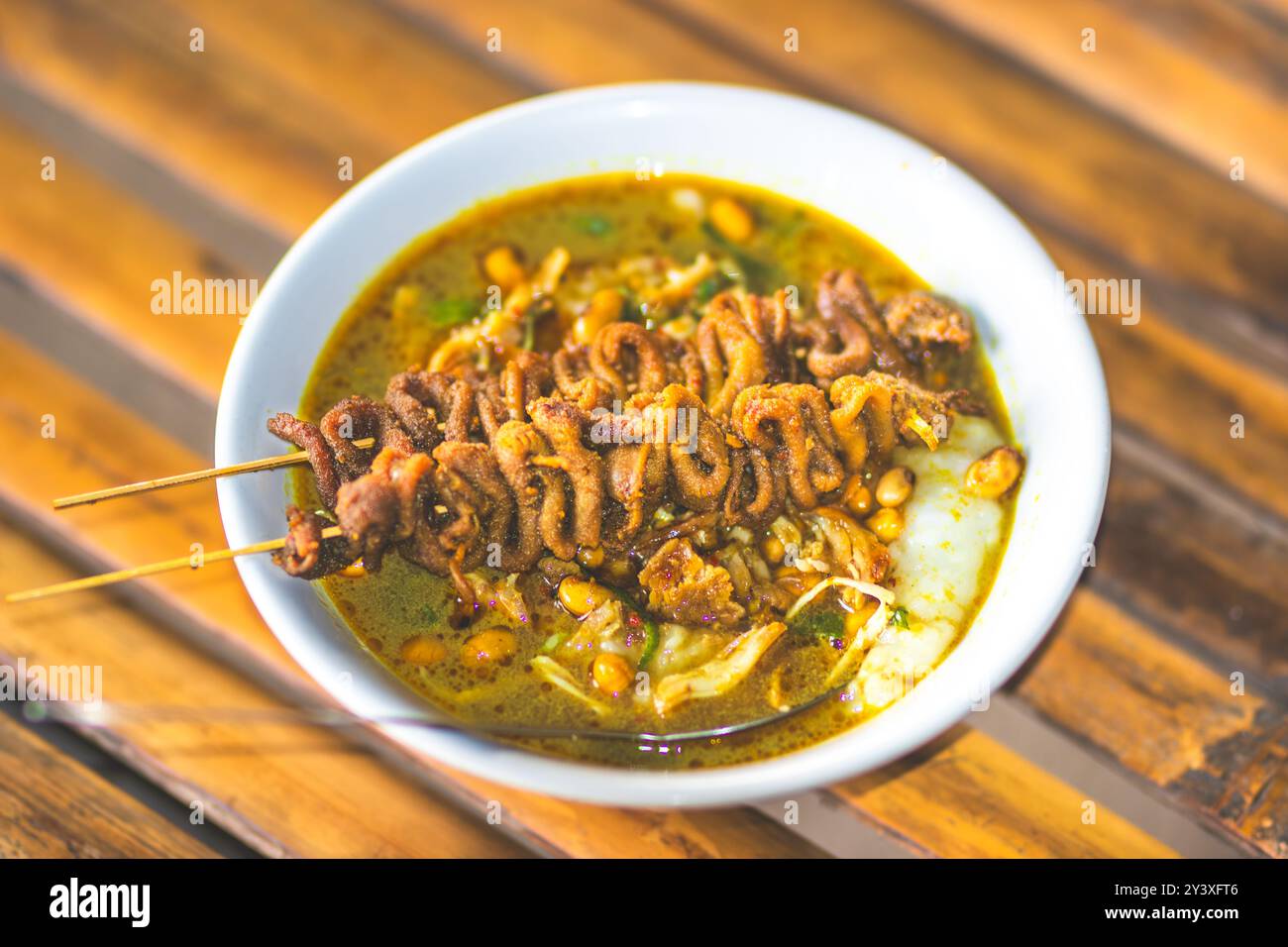 Chicken porridge bowl served with unique dishes. Traditional chicken ...