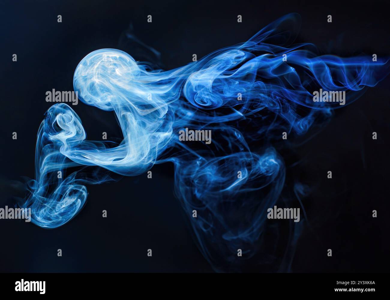 Blue smoke forms a dynamic, abstract figure with a dark background ...