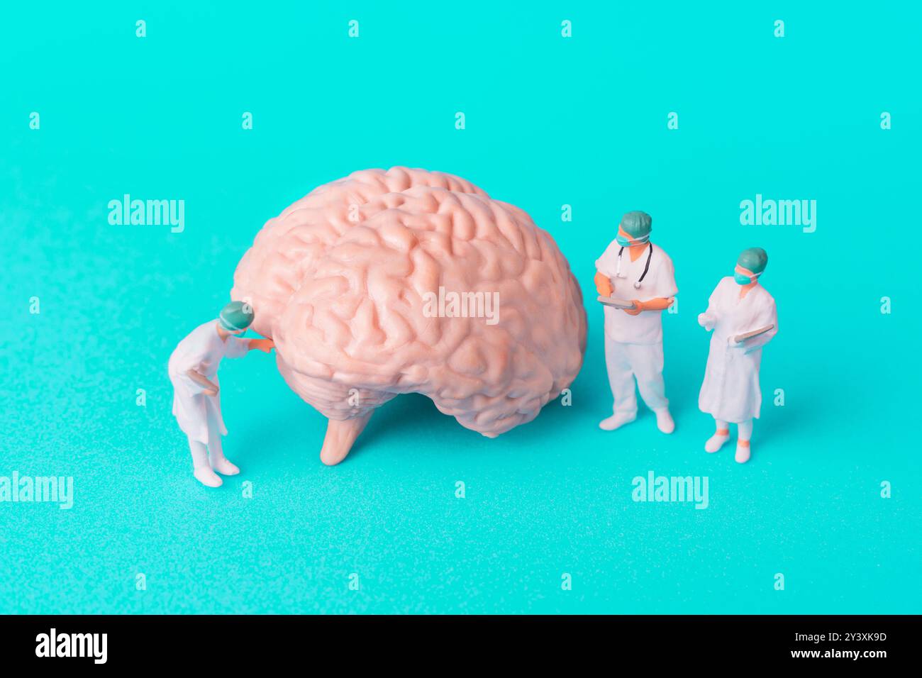 Group of miniature doctors examining a brain model, highlighting the ...