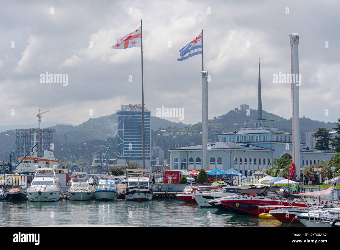 Flags of Georgia and Adjara over boats in the port. BATUMI, GEORGIA ...