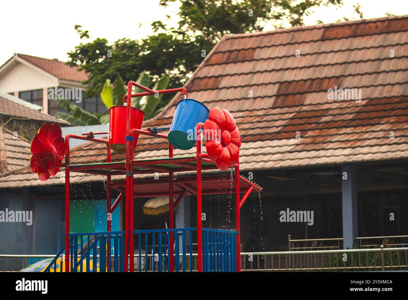 Water spills on the water bucket attraction in water park. Water splash ...