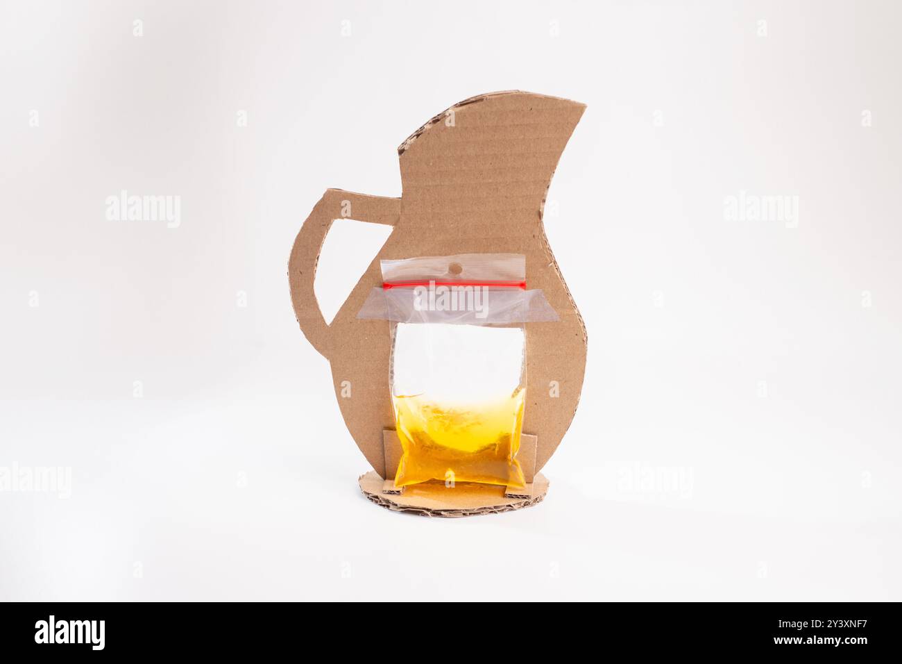 Cardboard pitcher craft: plastic bag with yellow colored water affixed ...