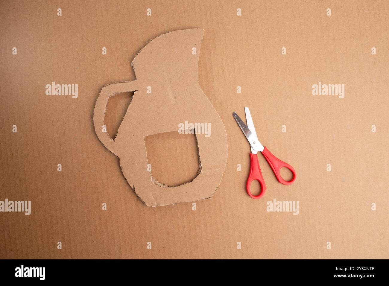 Assembling craft supplies: paper pitcher cut out, scissors, and ...
