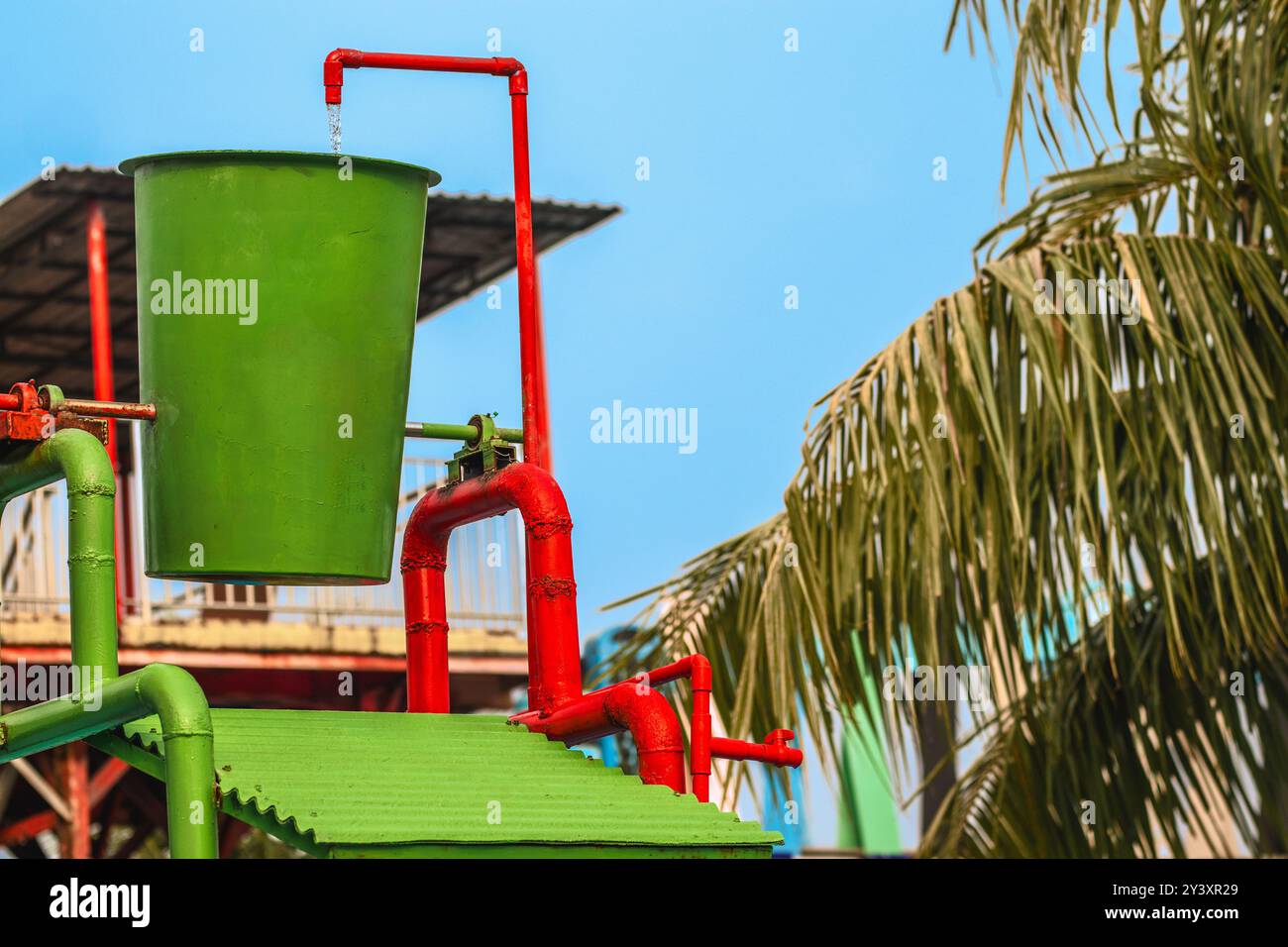 Water spills on the water bucket attraction in water park. Water splash ...