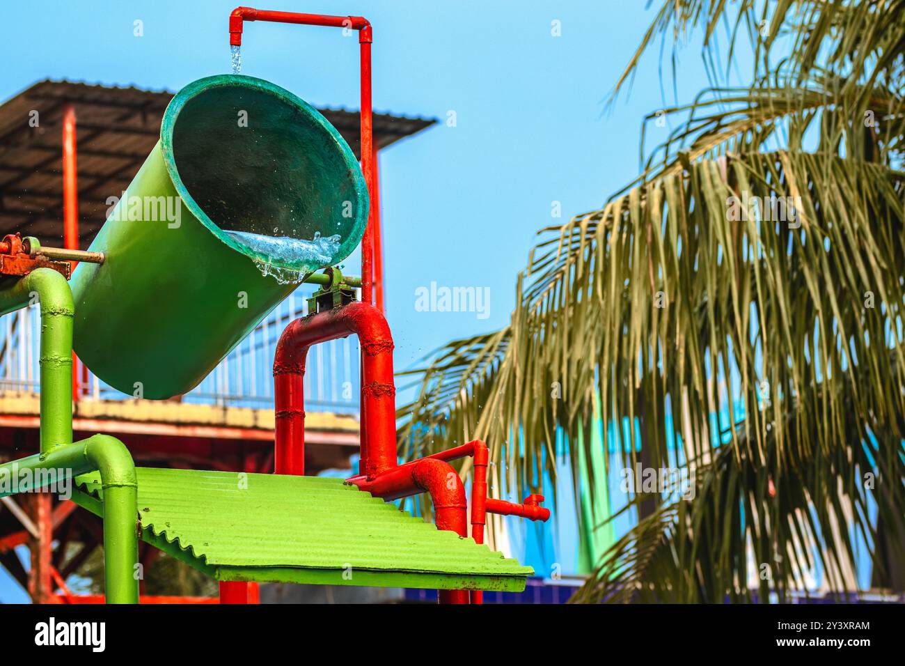 Water spills on the water bucket attraction in water park. Water splash ...