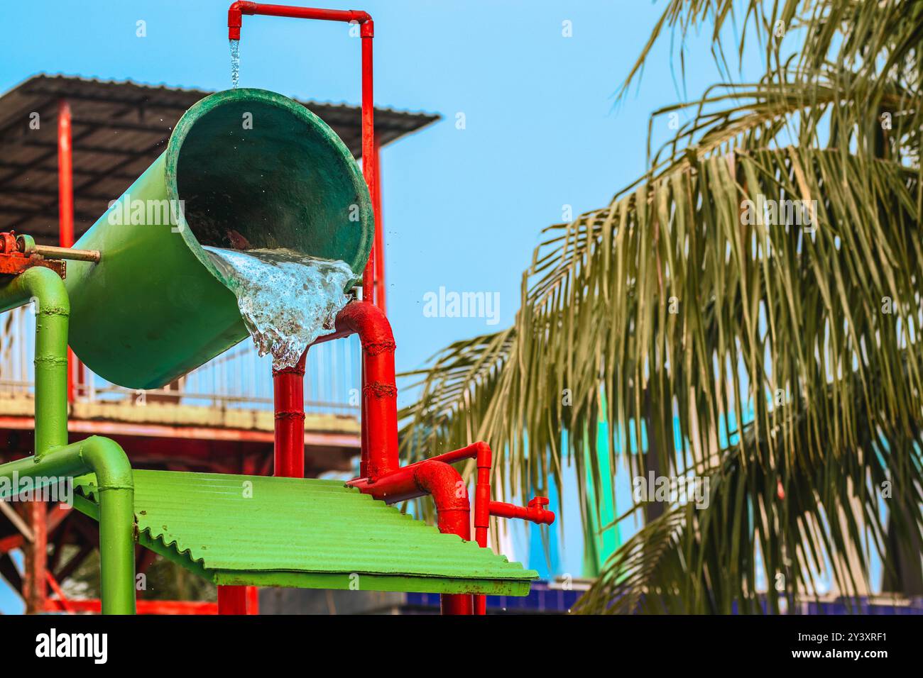 Water spills on the water bucket attraction in water park. Water splash ...