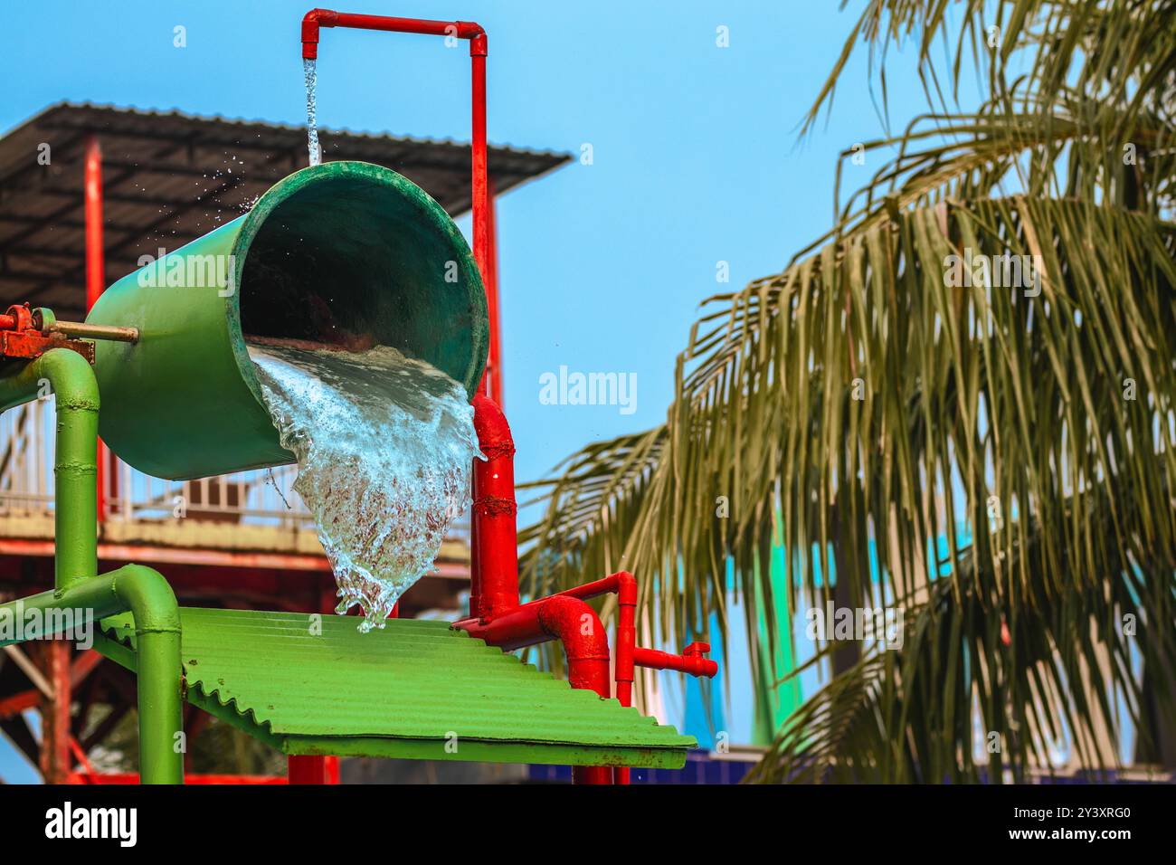 Water spills on the water bucket attraction in water park. Water splash ...