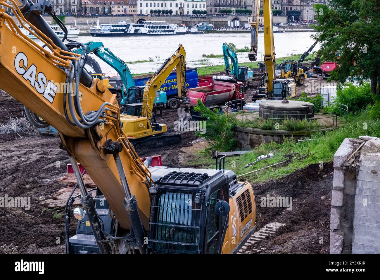 Excavators and trucks on the demolition site of the blasted section of ...