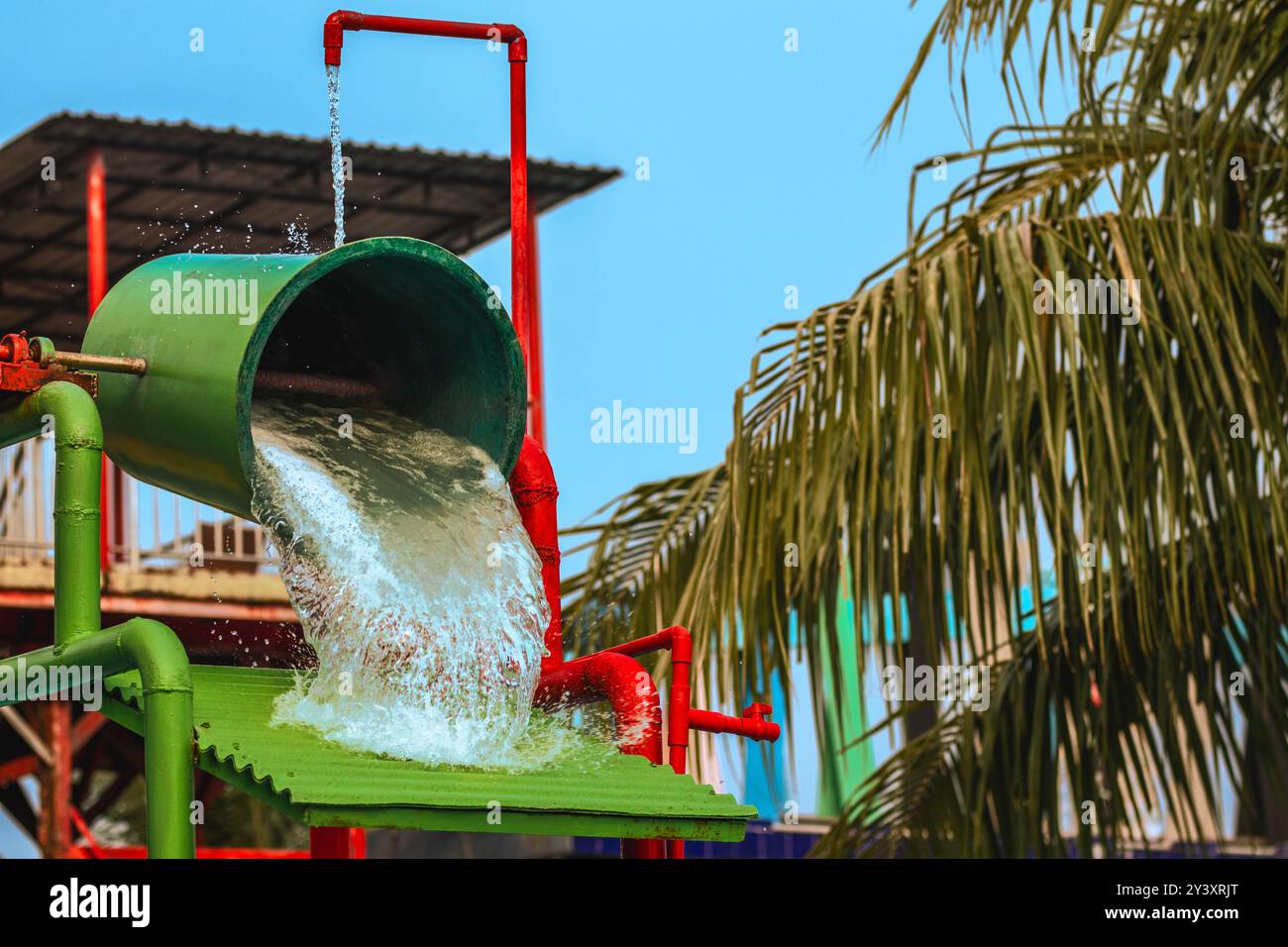 Water spills on the water bucket attraction in water park. Water splash ...