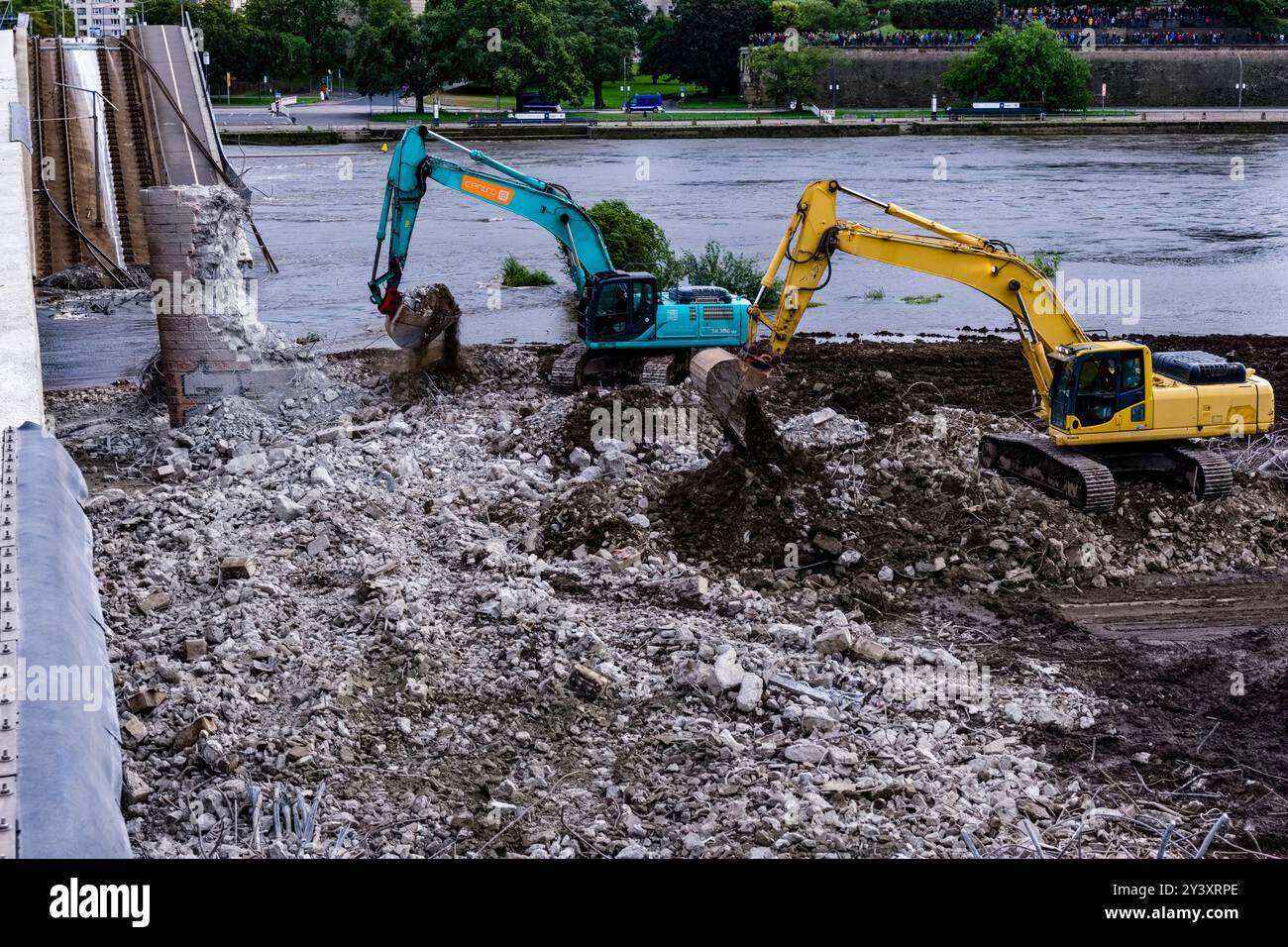 Two excavators working on the demolition site of the blasted section of ...
