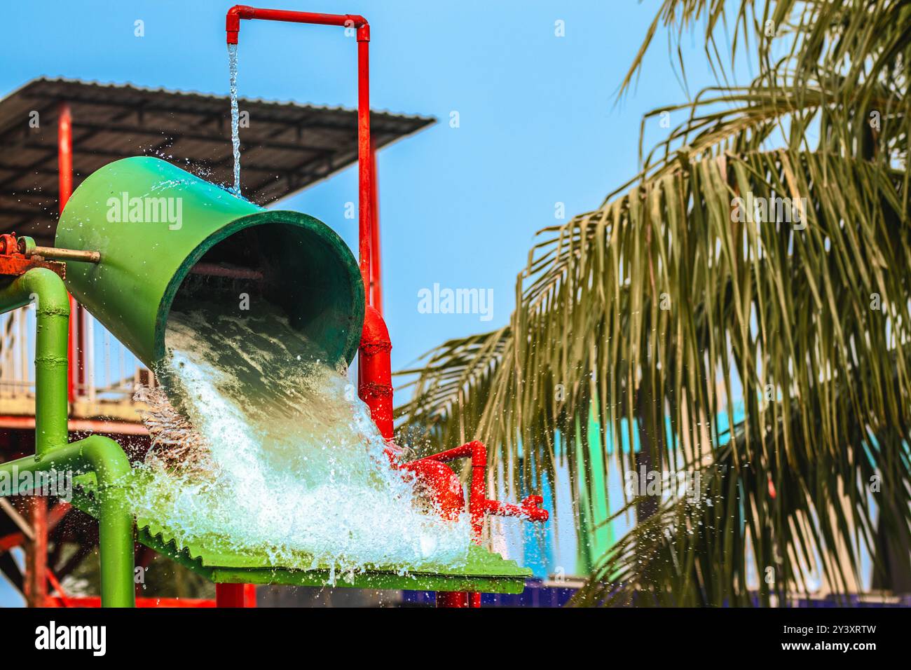 Water spills on the water bucket attraction in water park. Water splash ...