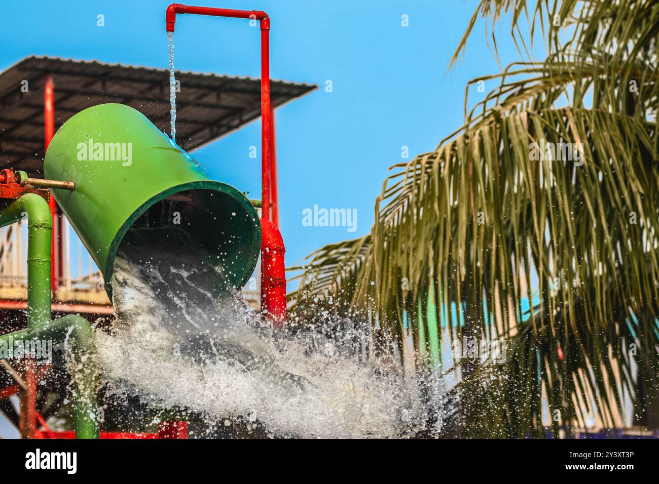 Water spills on the water bucket attraction in water park. Water splash ...