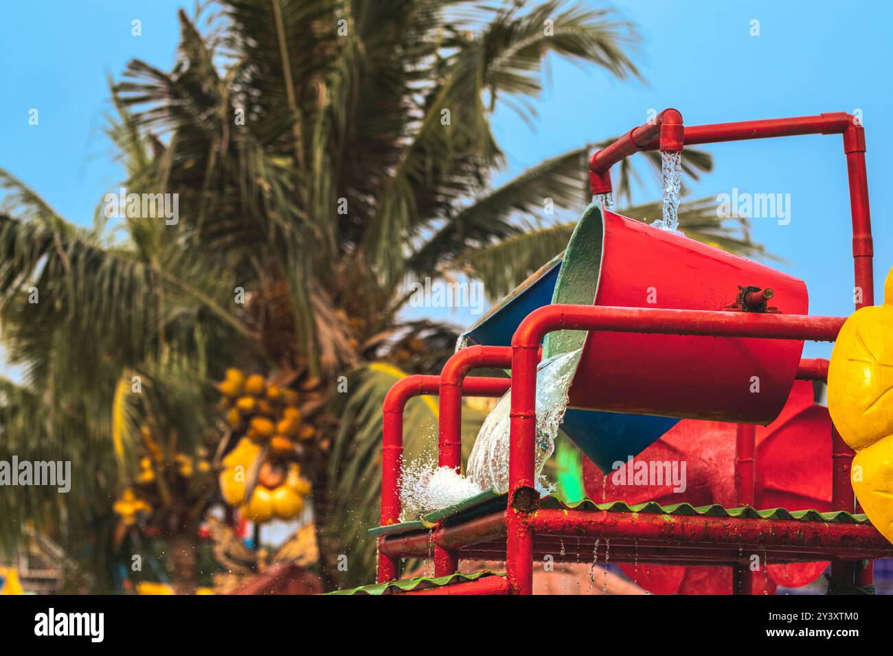 Water spills on the water bucket attraction in water park. Water splash ...