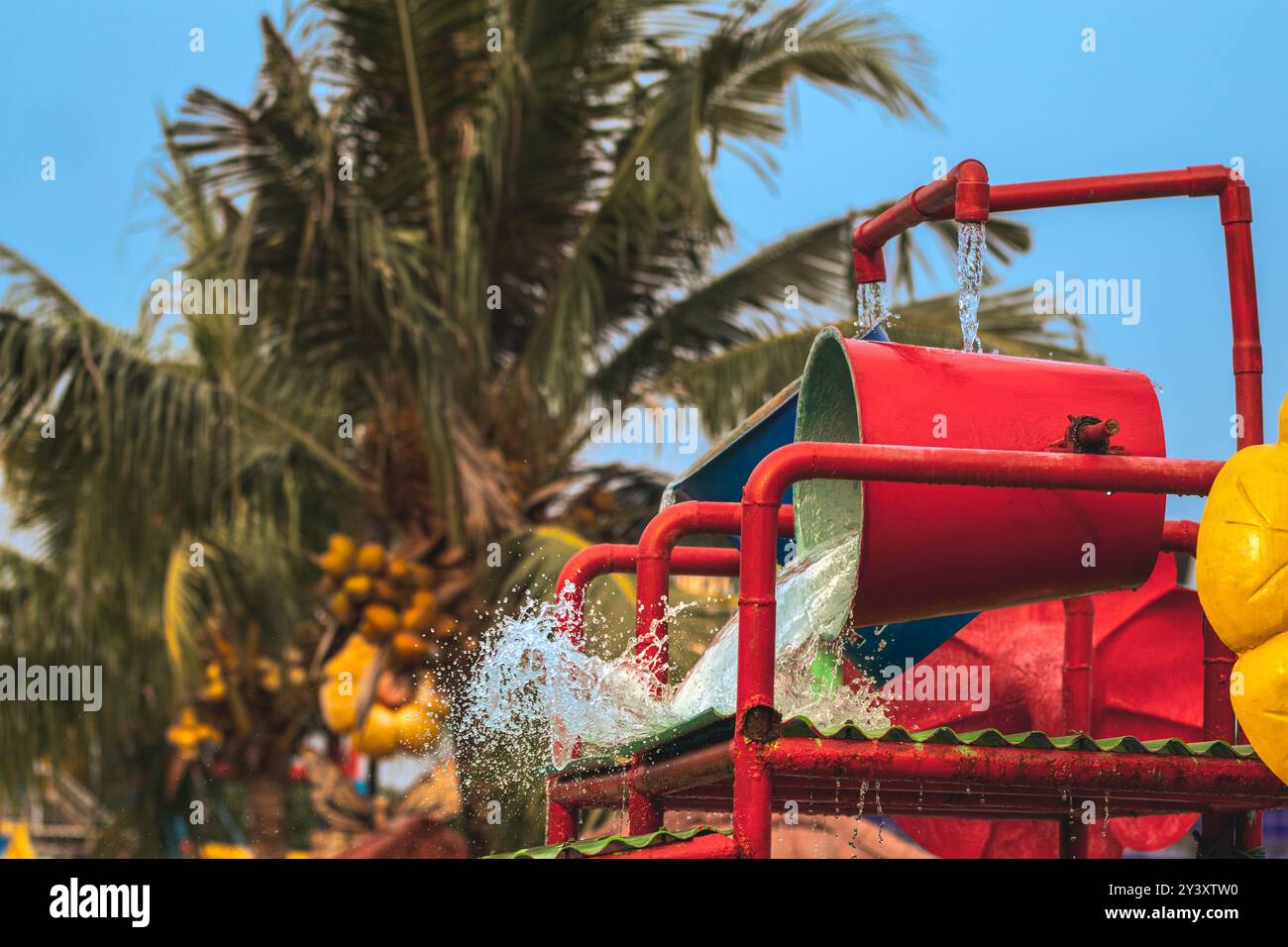 Water spills on the water bucket attraction in water park. Water splash ...