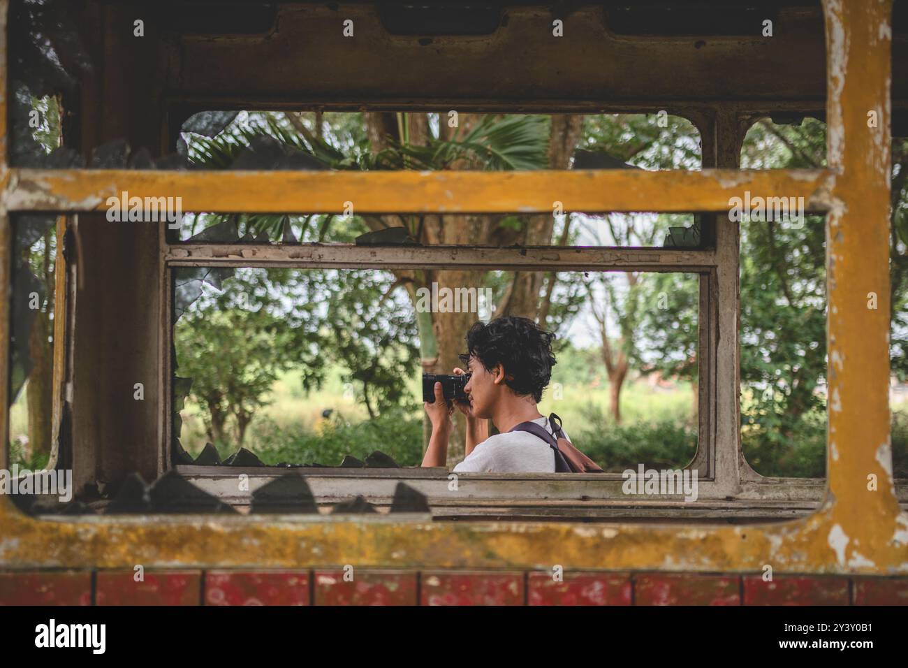 Man pointing camera to taking photo. Side view of young man with her ...