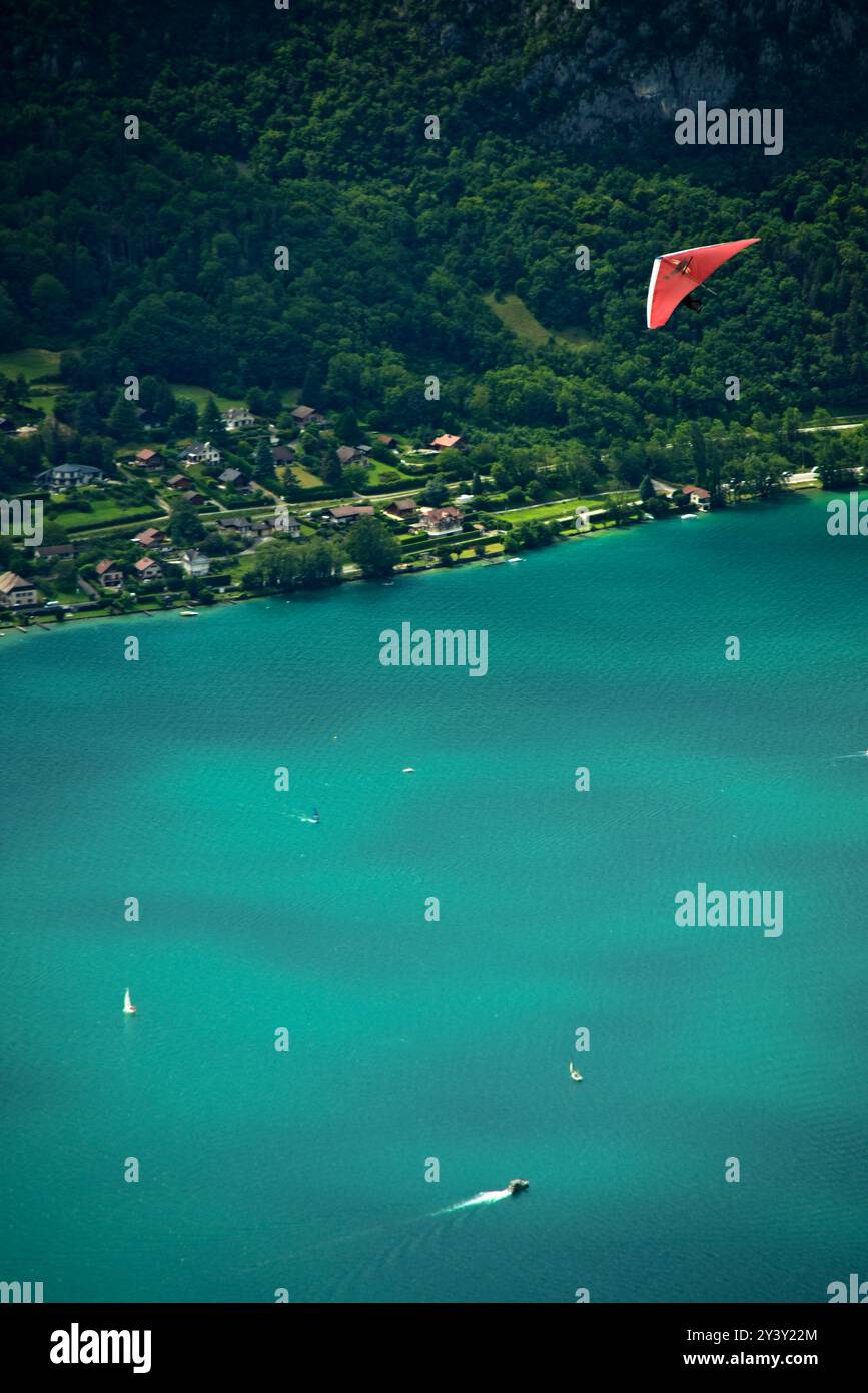 Aerial view and close up on Annecy Lake with boat cruising on the blue ...