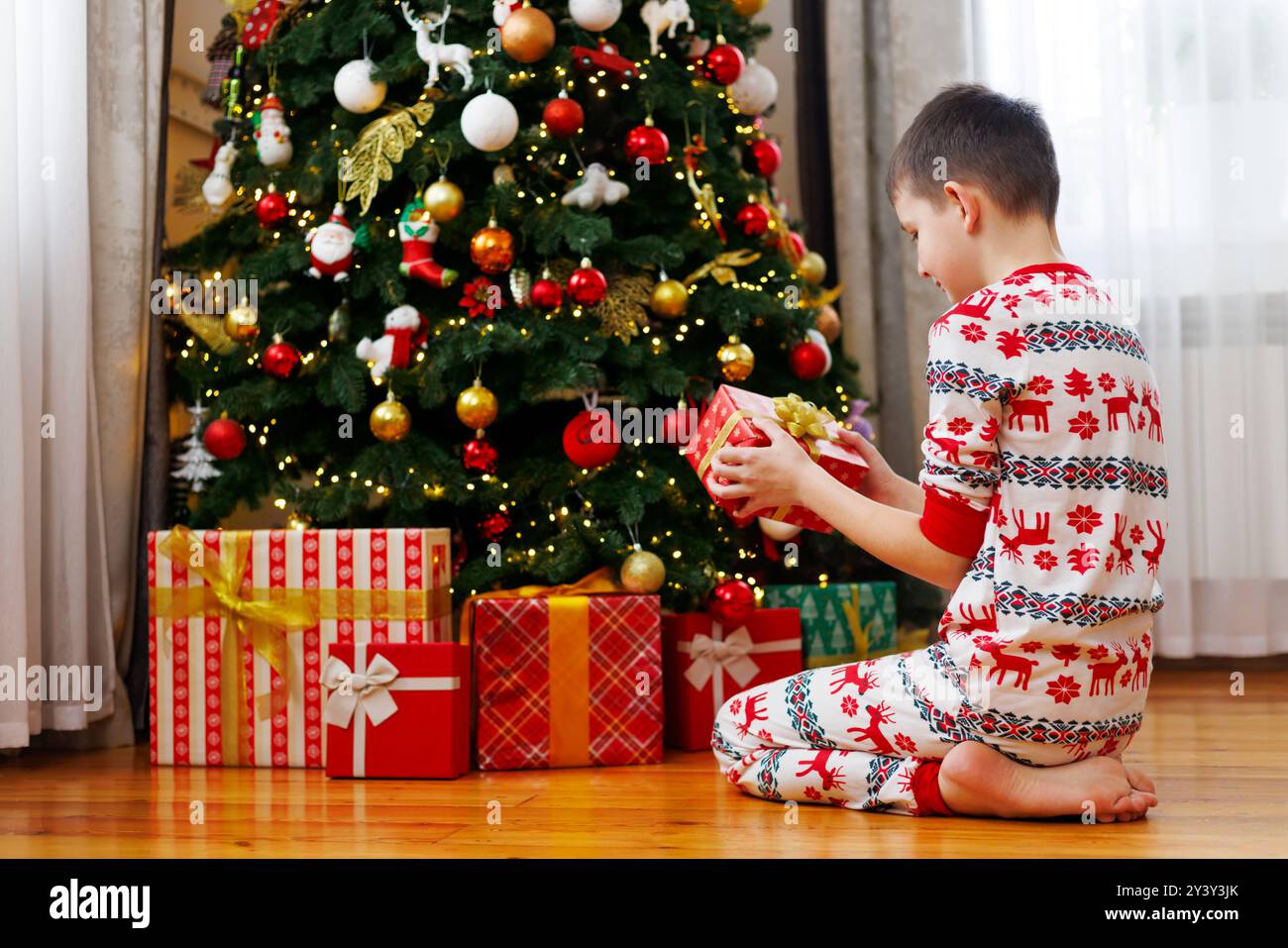 Child giving christmas present indoor hi-res stock photography and ...