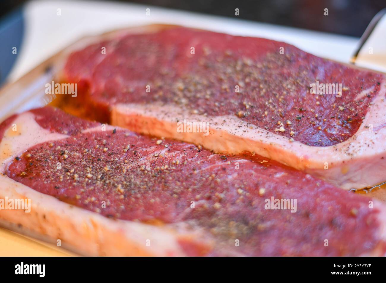 beef stake on a griddle hot plate pan Stock Photo - Alamy