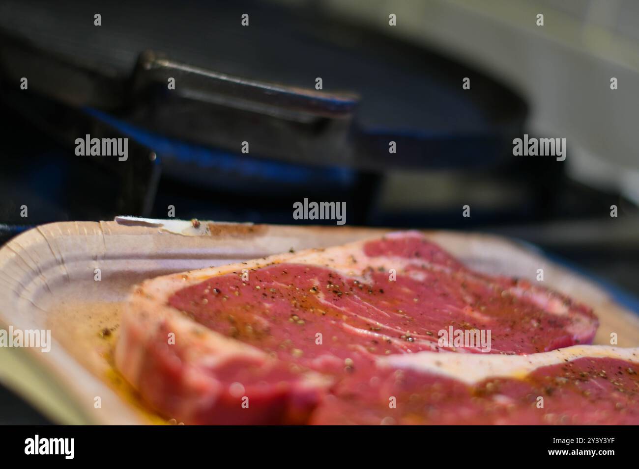 beef stake on a griddle hot plate pan Stock Photo - Alamy
