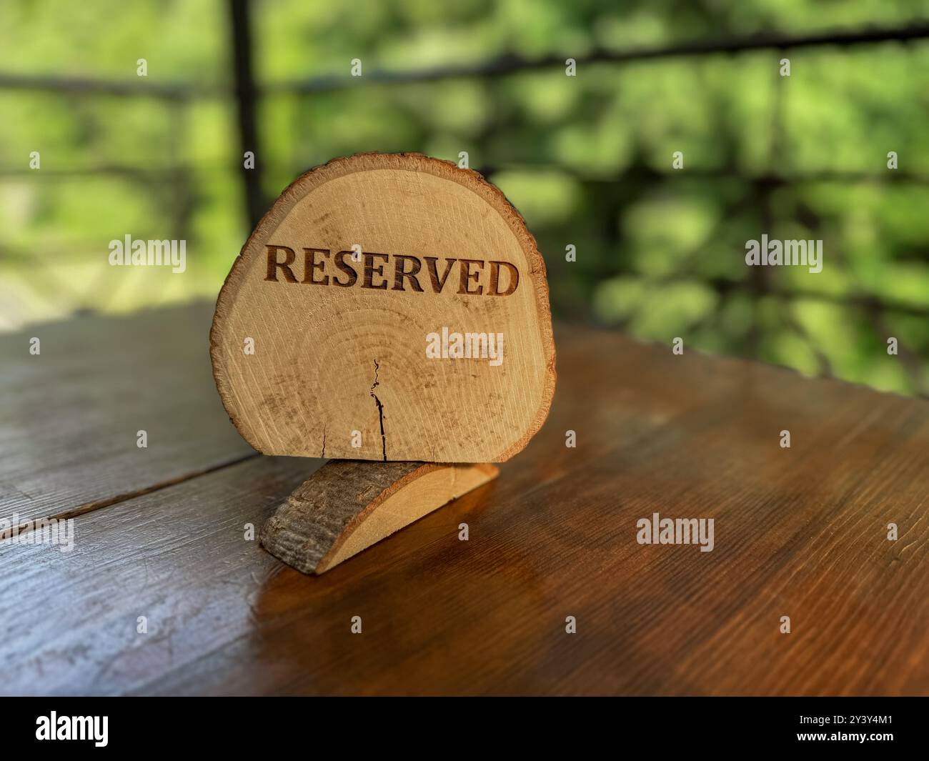 Reserved wooden sign on a rustic table in a cozy dining setting during ...