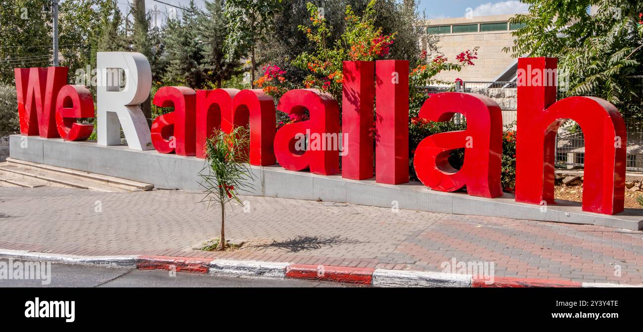 Large red letters of a sign in the Old Town district of Ramallah ...