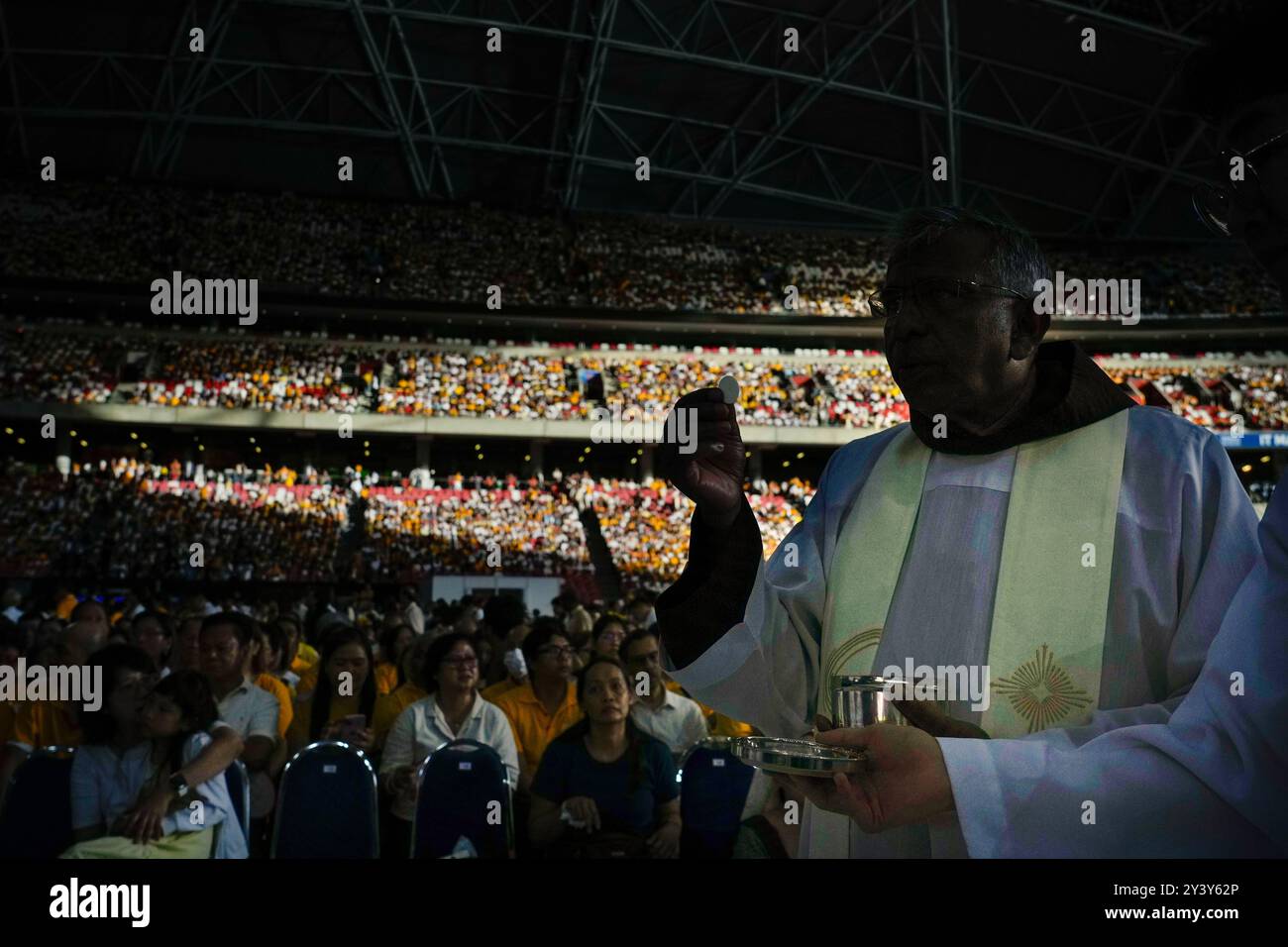 The holy communion is given to the faithful during a mass 'In Memory of ...