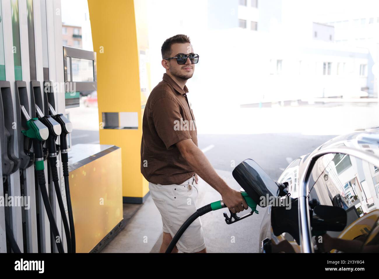 Handsome man using gasoline nozzle hi-res stock photography and images ...