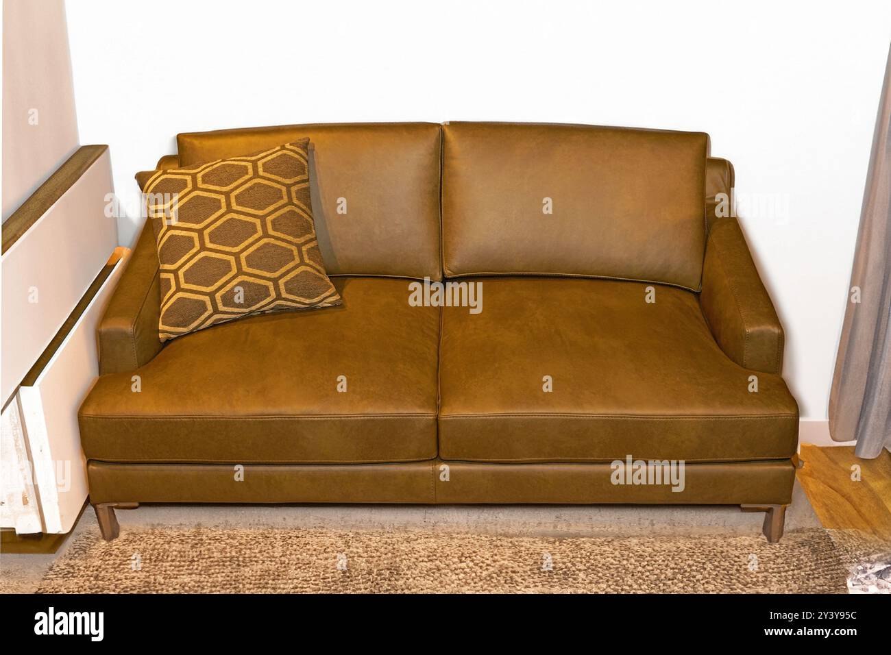 Brown sofa with large pillow in the corner inside modern interior Stock ...