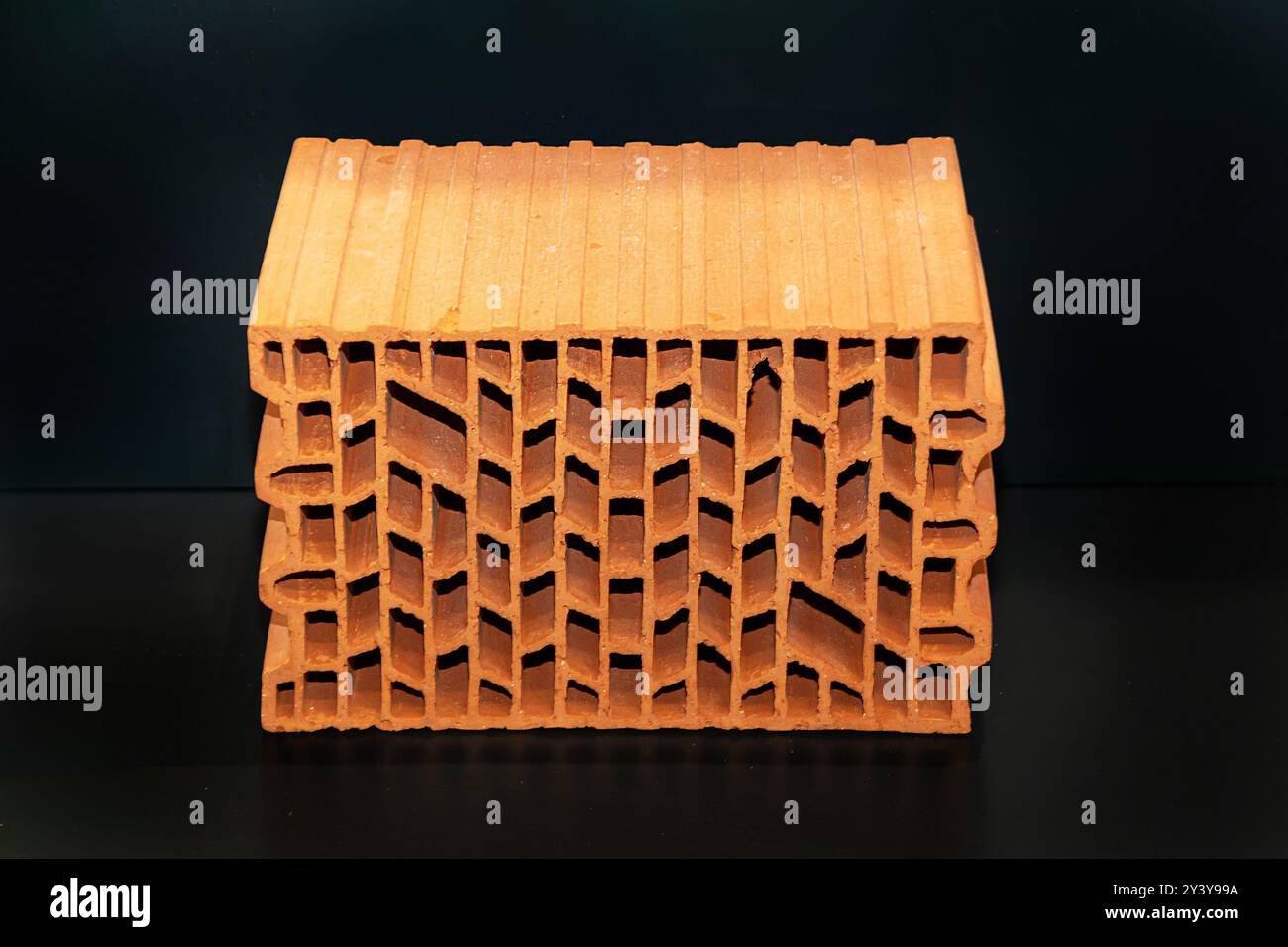 Hollow brick used in construction industry isolated on black background ...