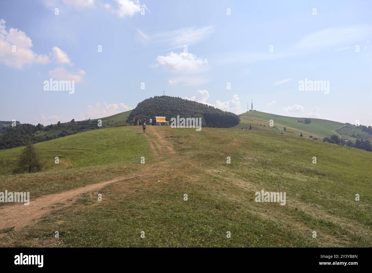 Small plateau on a mountain peak with groves and antennae on the peaks ...