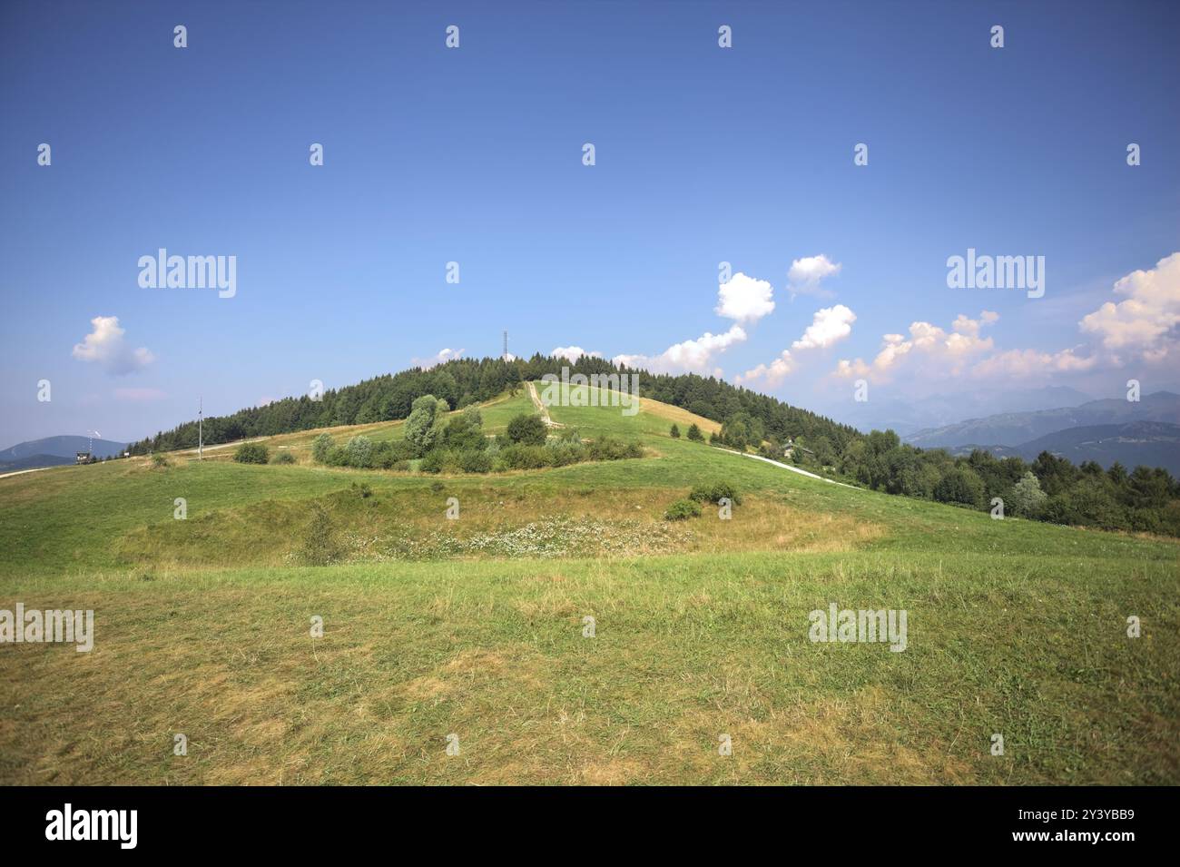 Small plateau on a mountain peak with groves and antennae on the peaks ...