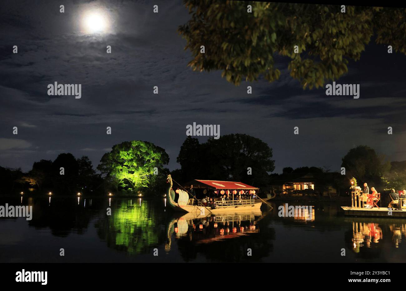 Participants on a boat enjoy viewing the moon during the Kangetsu-no ...